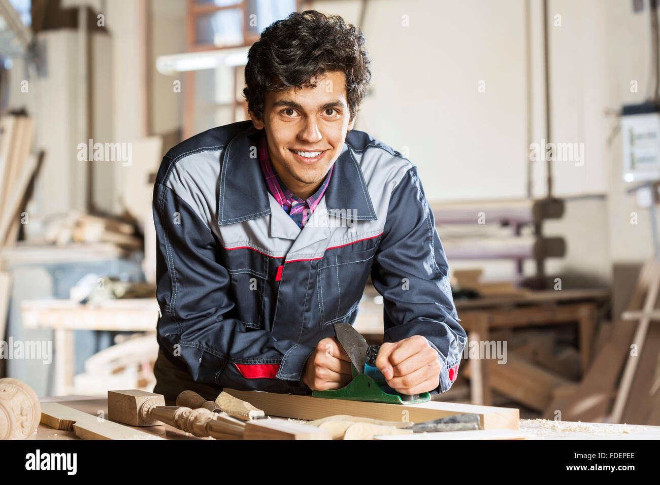 Young carpenter working with cutter in his studio Stock Photo - Alamy