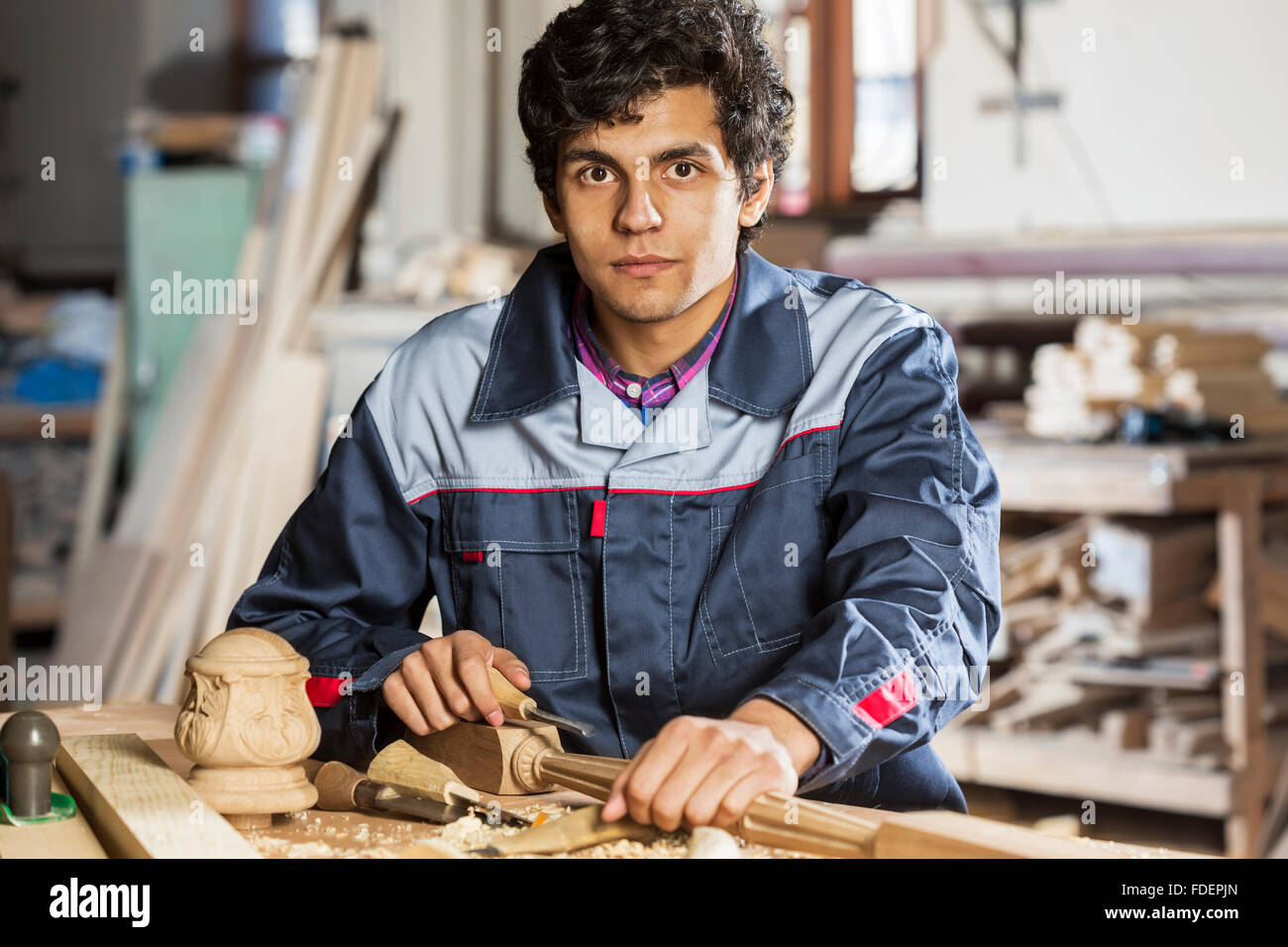 Young carpenter working with cutter in his studio Stock Photo - Alamy