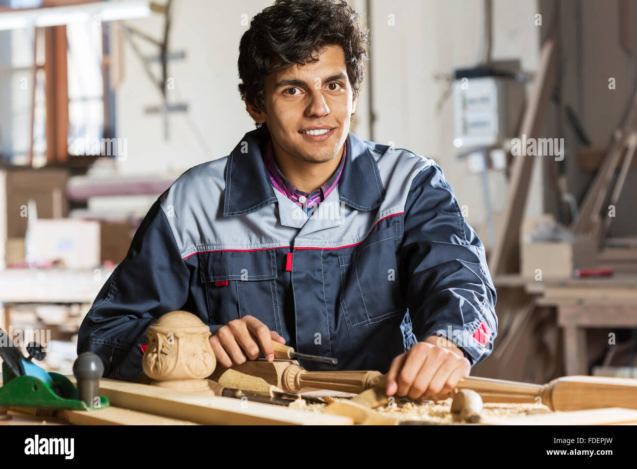 Young carpenter working with cutter in his studio Stock Photo - Alamy