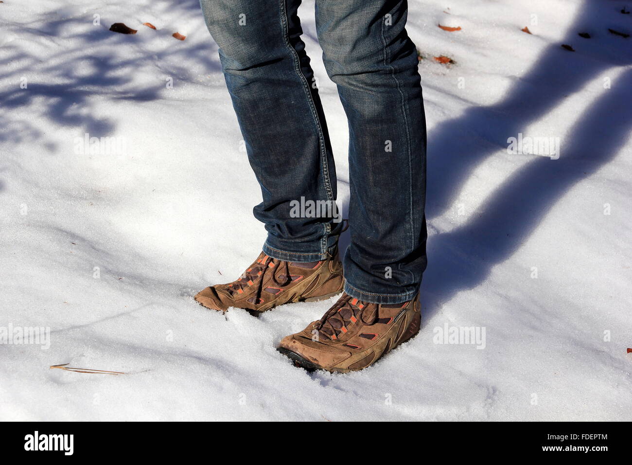 with the walking boots in the snow Stock Photo - Alamy