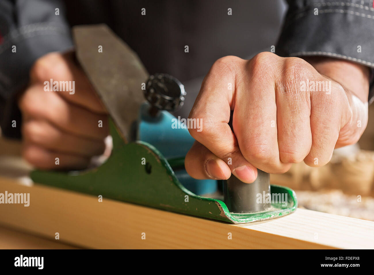Close up of carpenter hands working with plane in his studio Stock ...