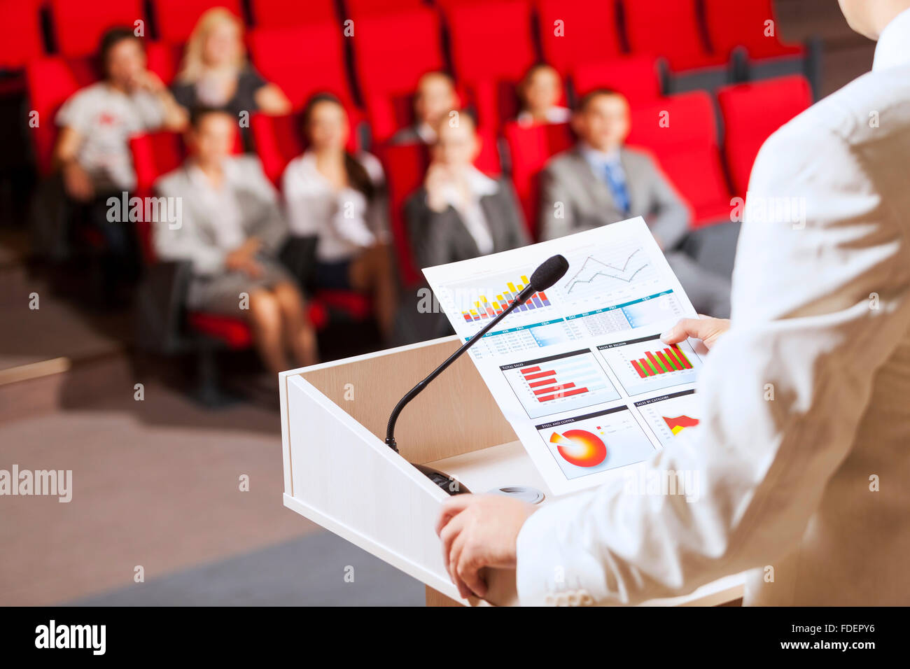 Businessman standing on stage and reporting for audience Stock Photo ...