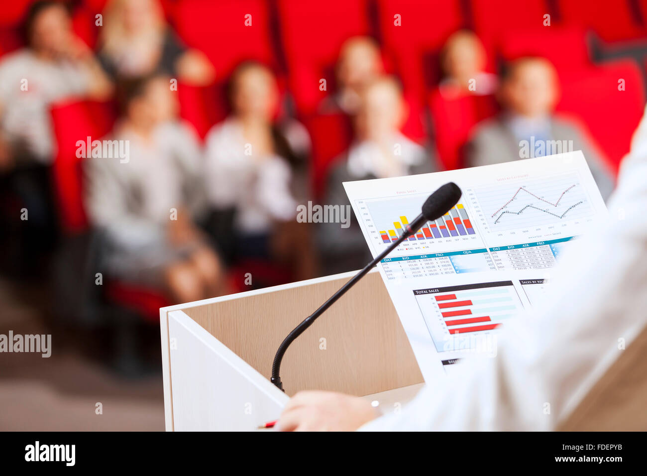 Businessman standing on stage and reporting for audience Stock Photo ...