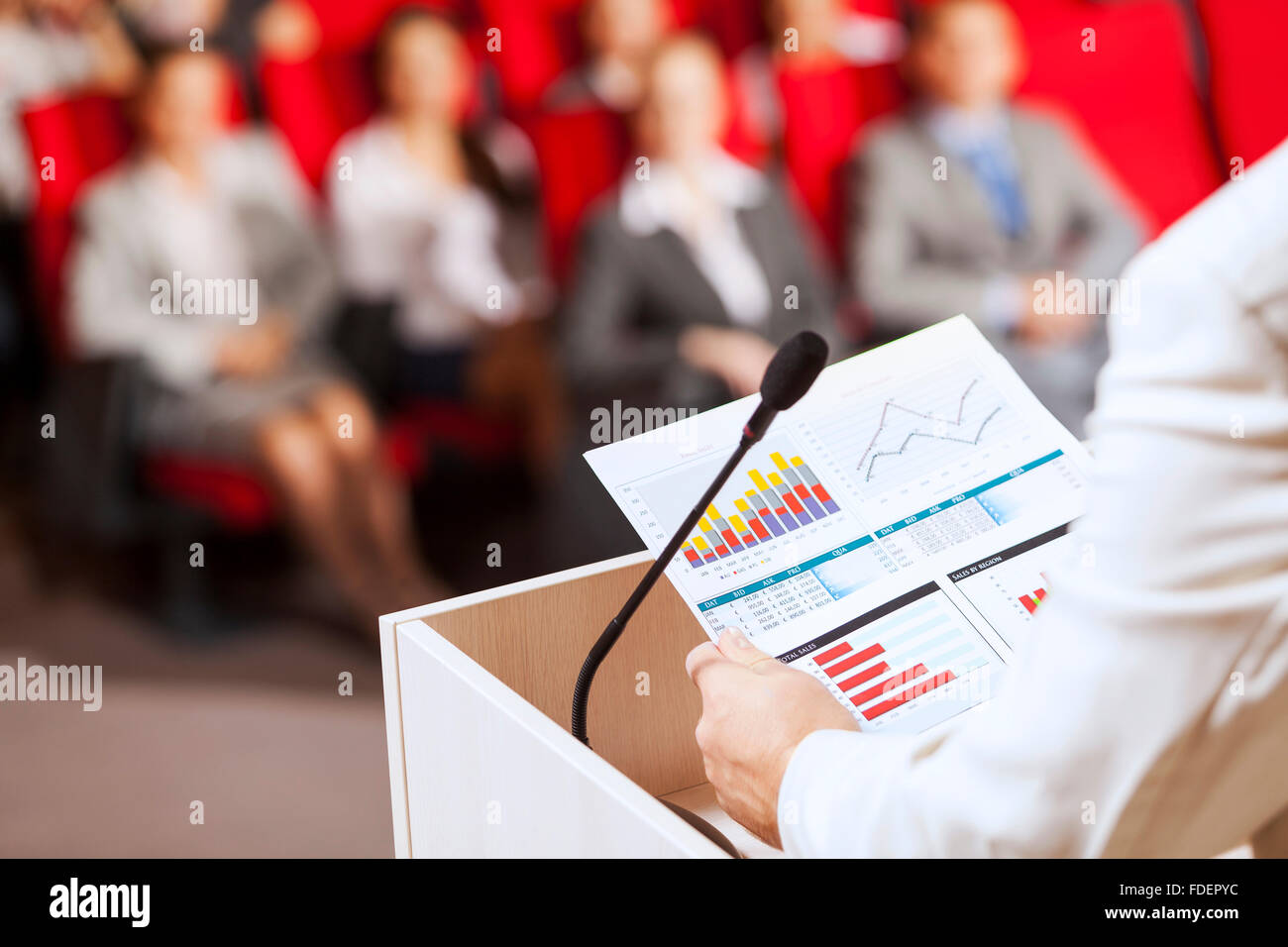 Businessman standing on stage and reporting for audience Stock Photo ...