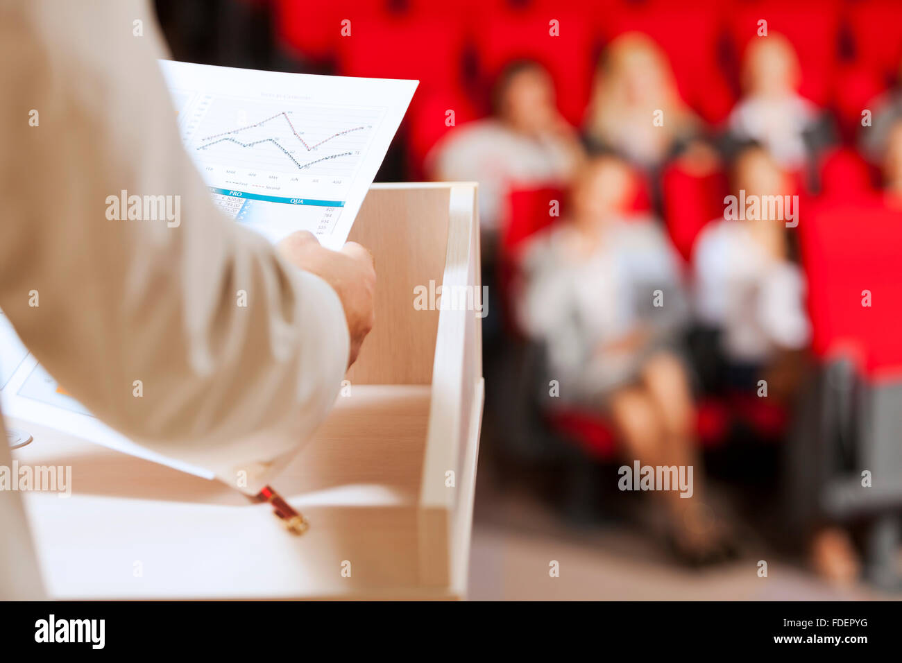 Businessman standing on stage and reporting for audience Stock Photo ...