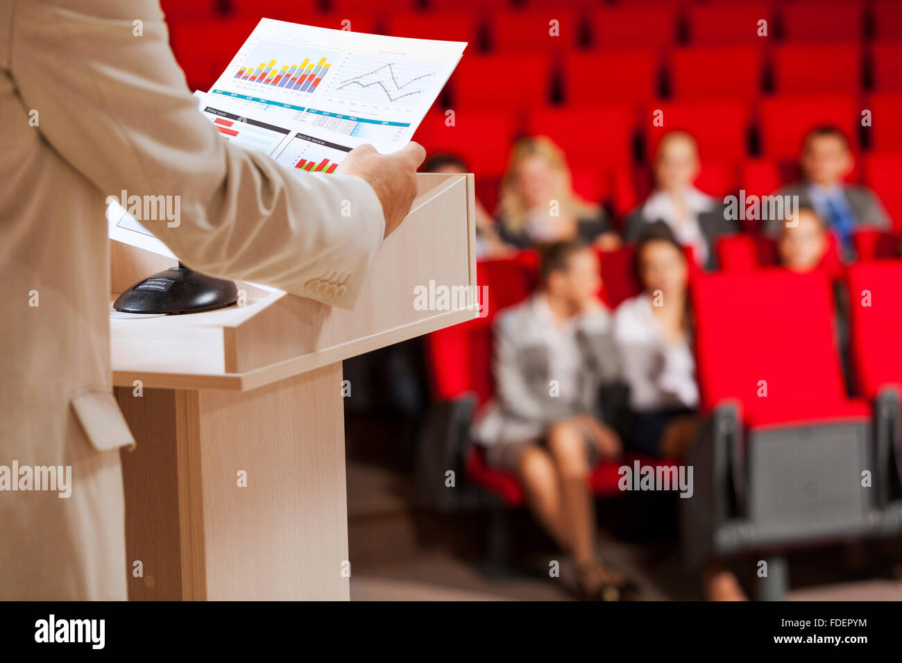 Businessman standing on stage and reporting for audience Stock Photo ...