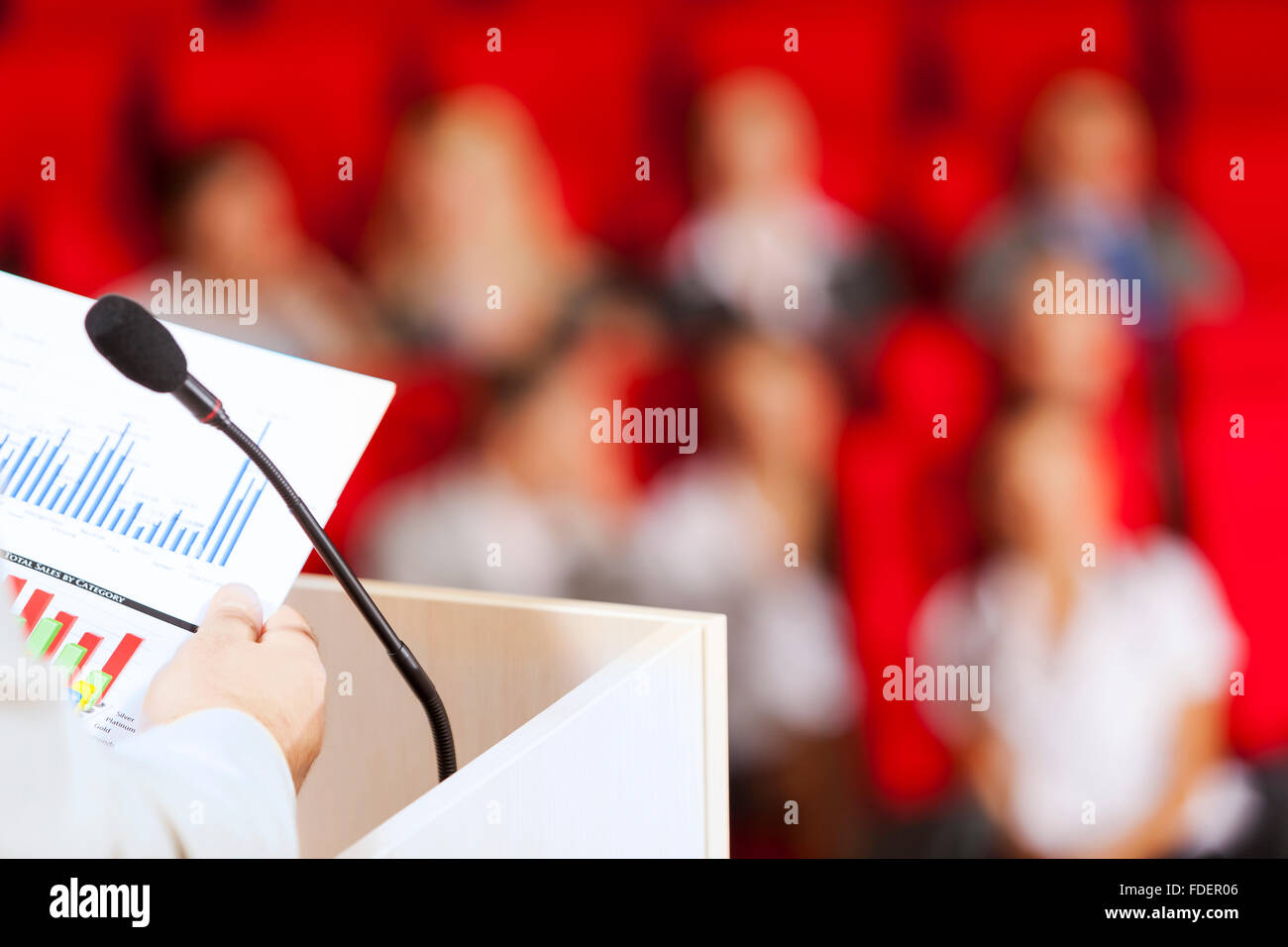 Businessman standing on stage and reporting for audience Stock Photo ...