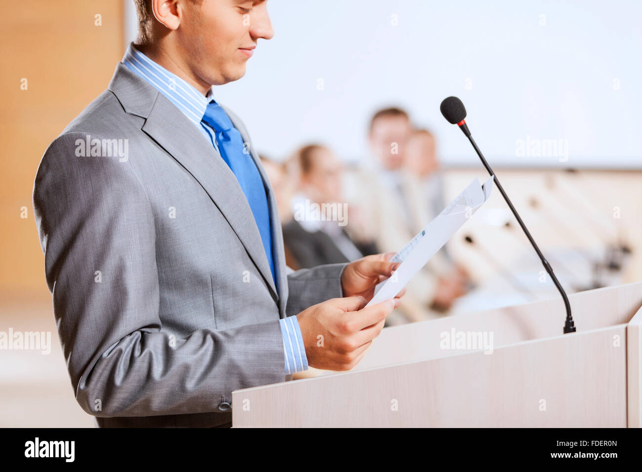 Businessman standing on stage and reporting for audience Stock Photo ...