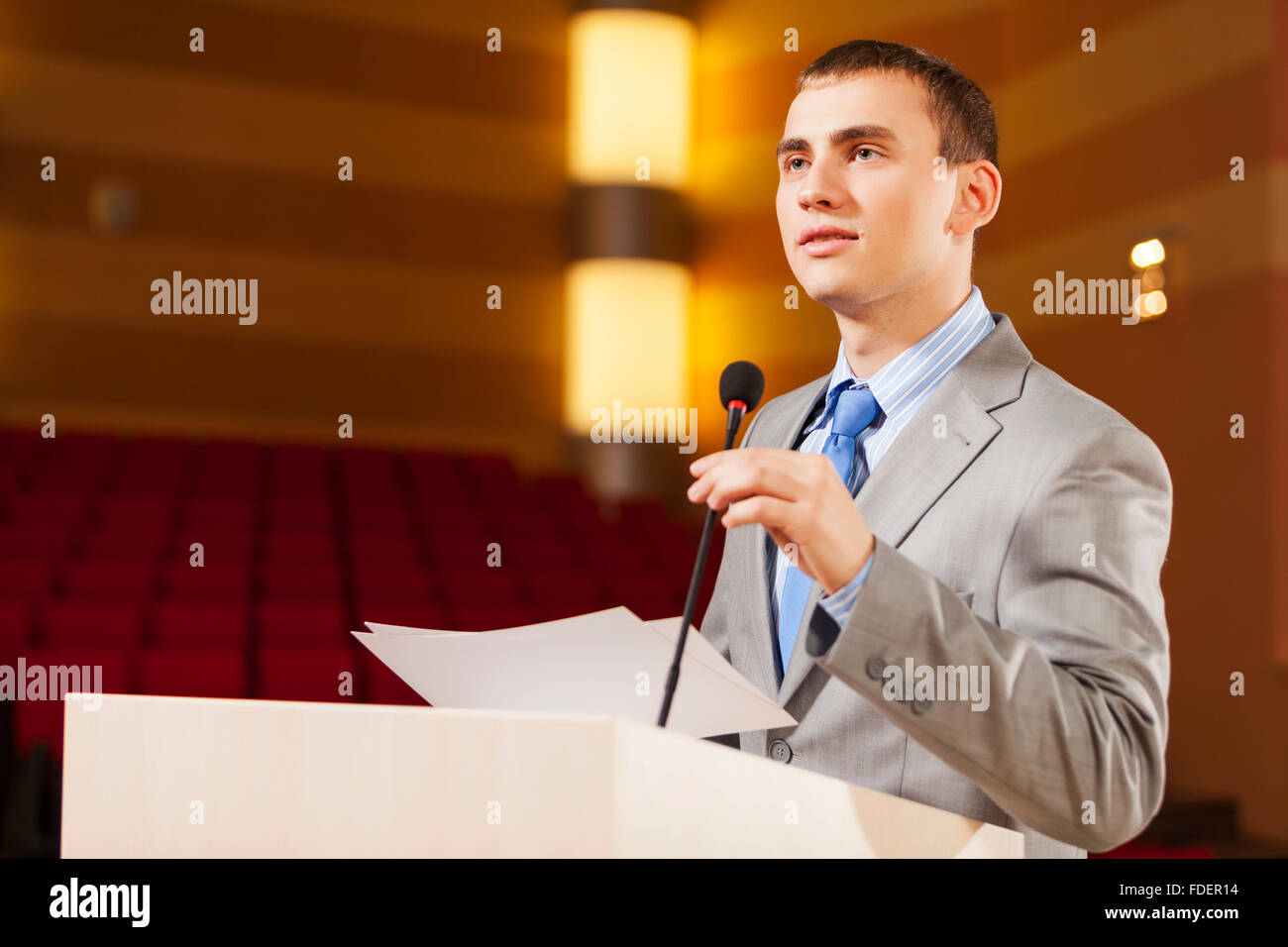 Businessman standing on stage and reporting for audience Stock Photo ...
