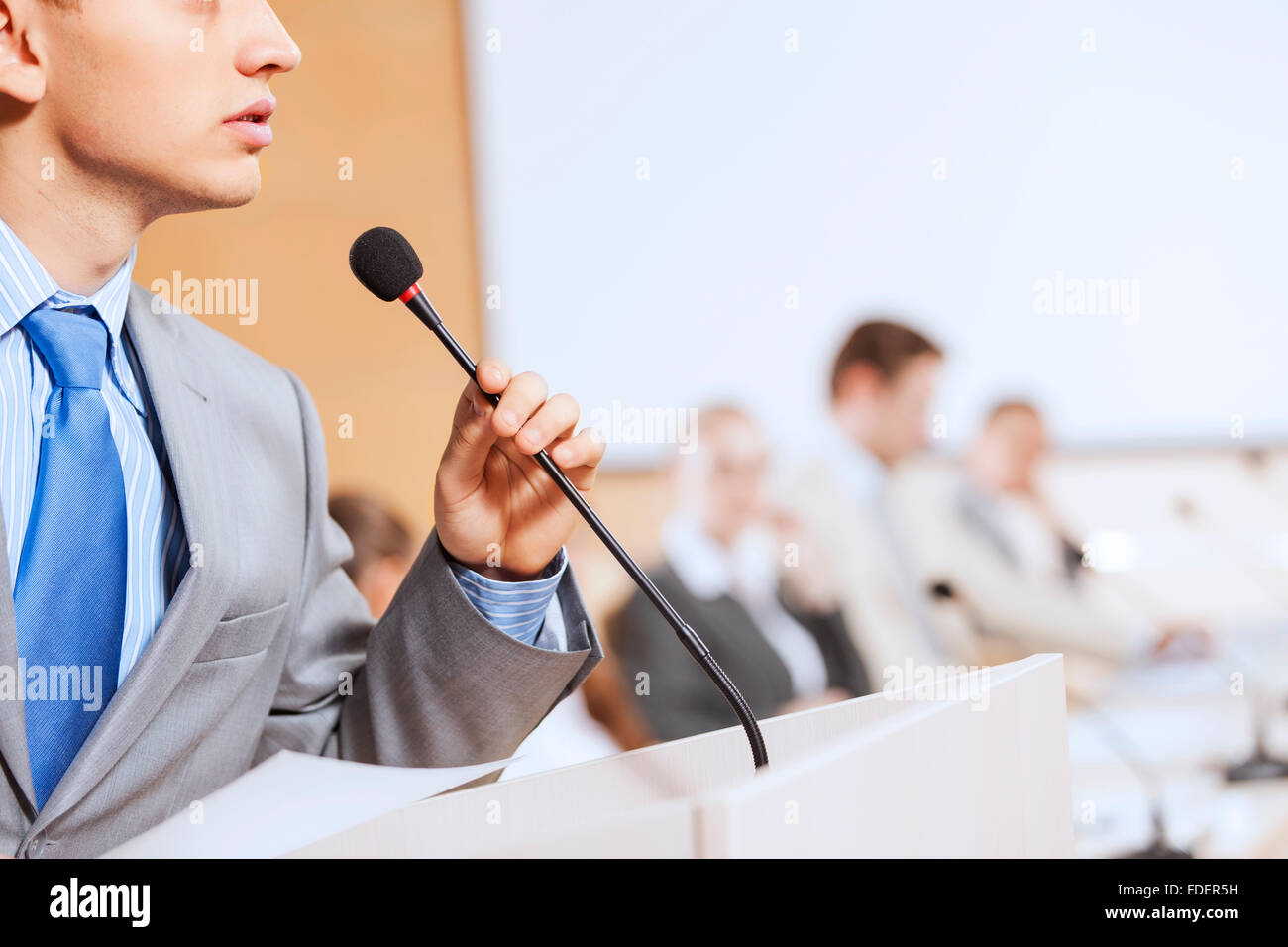 Businessman standing on stage and reporting for audience Stock Photo ...