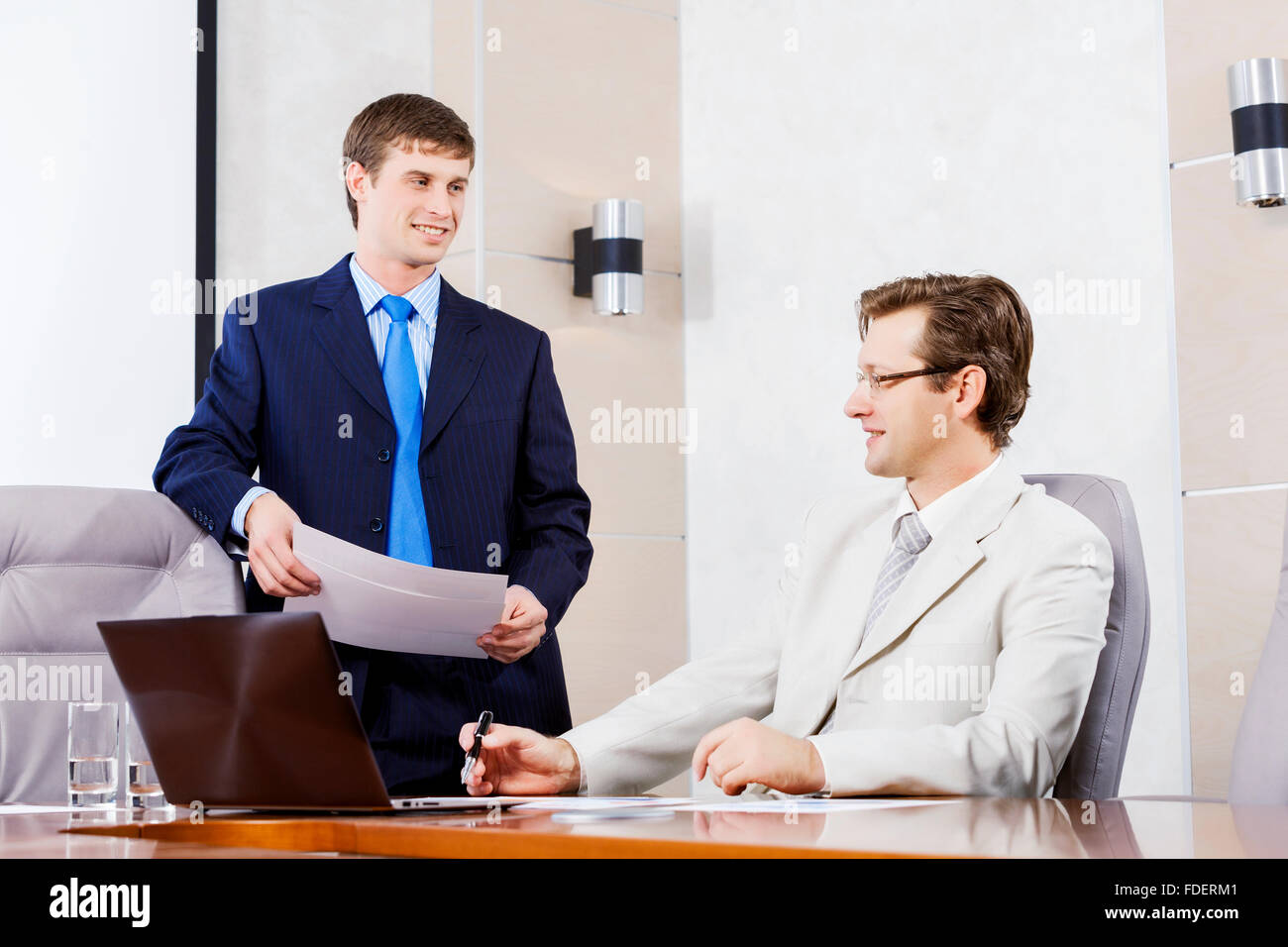Young businessman in office showing documents to his boss Stock Photo ...