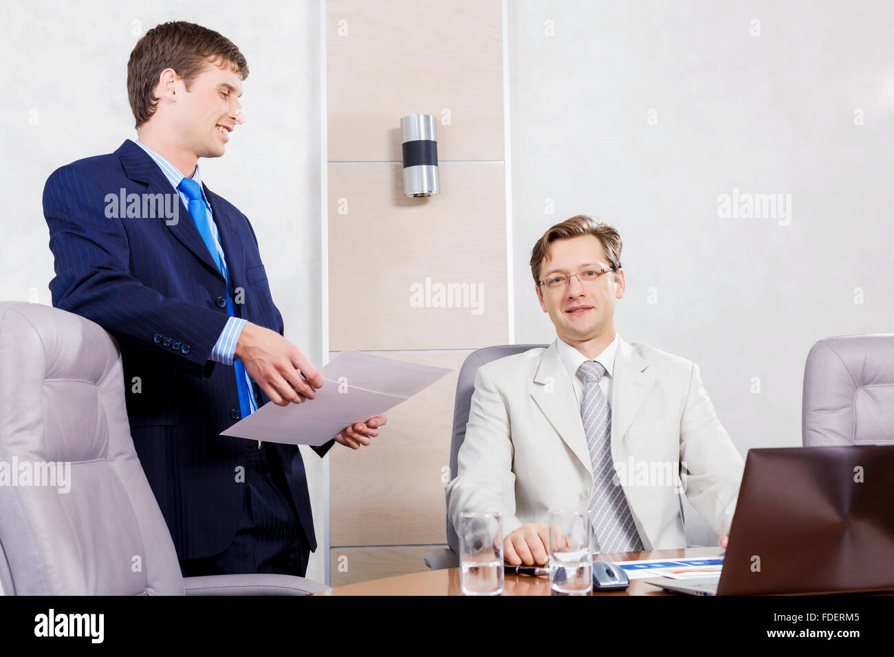 Young businessman in office showing documents to his boss Stock Photo ...