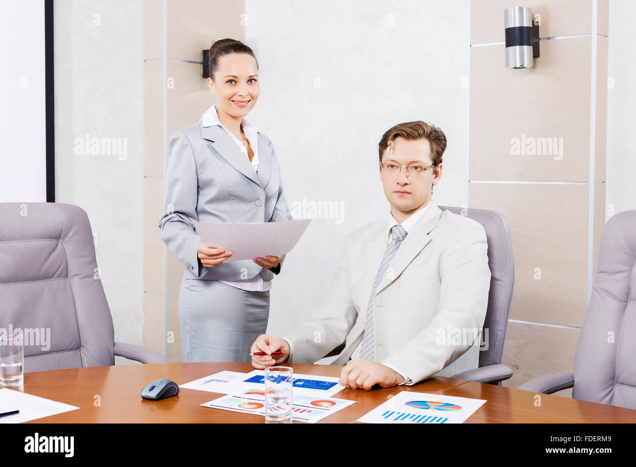 Young attractive secretary showing boss business documents Stock Photo ...