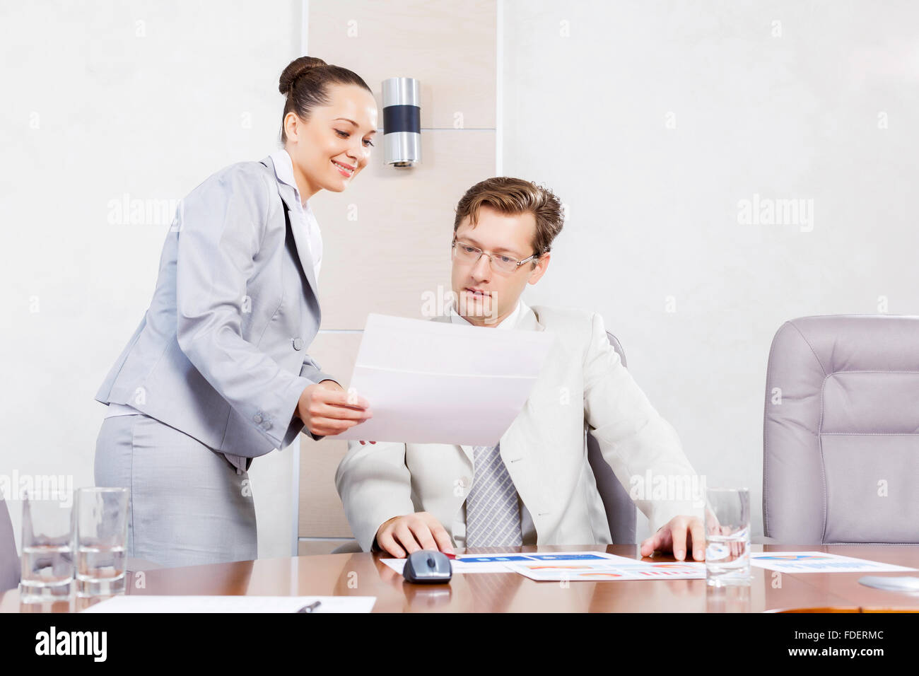 Young attractive secretary showing boss business documents Stock Photo ... Young attractive secretary showing boss business documents Stock Photo ...