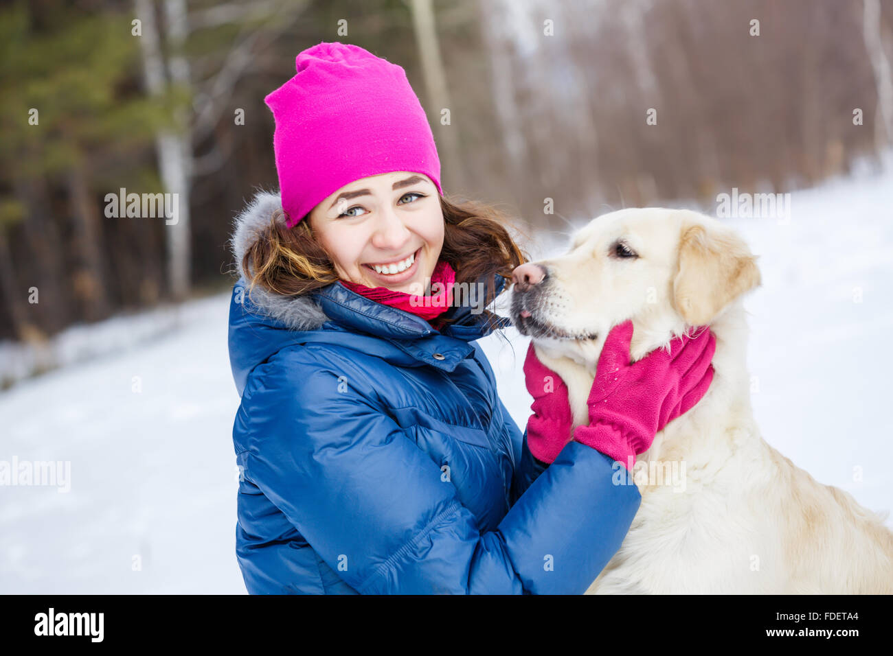 Girl with labrador dog on walk in winter park Stock Photo - Alamy