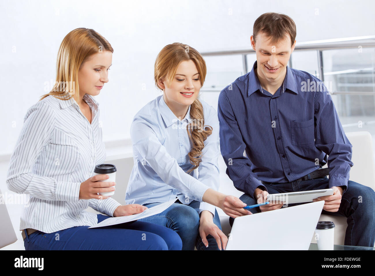 Three co-workers discussing business ideas in office Stock Photo - Alamy
