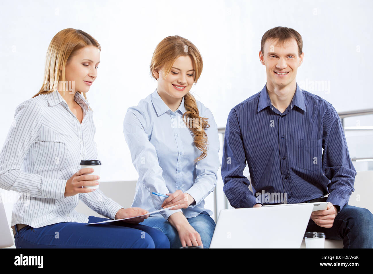 Three co-workers discussing business ideas in office Stock Photo - Alamy