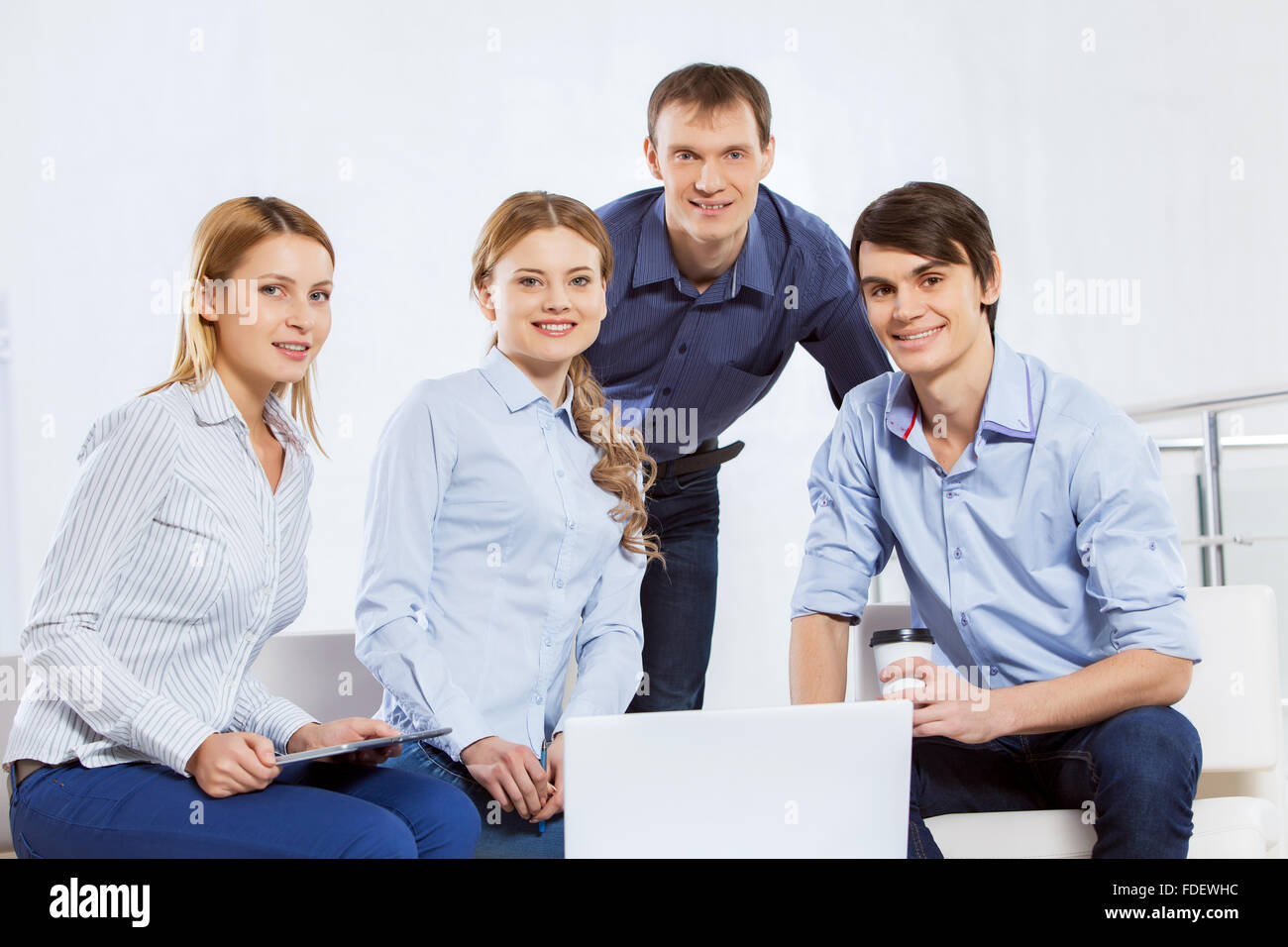 Four co-workers discussing business ideas in office Stock Photo - Alamy