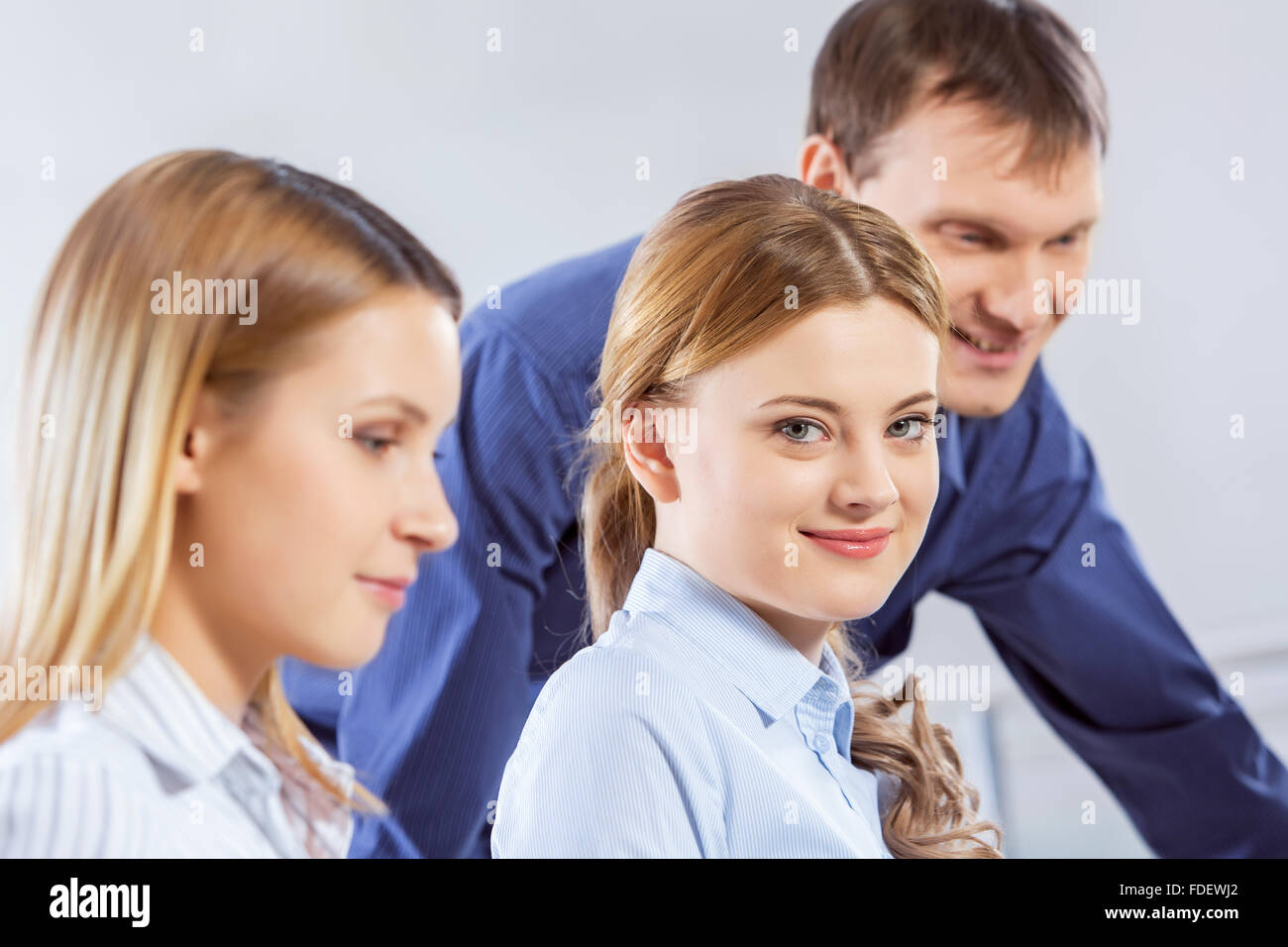 Three co-workers discussing business ideas in office Stock Photo - Alamy