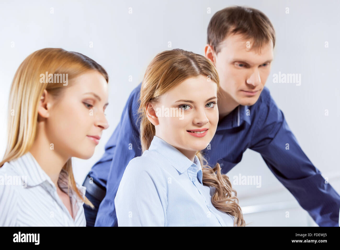 Three co-workers discussing business ideas in office Stock Photo - Alamy