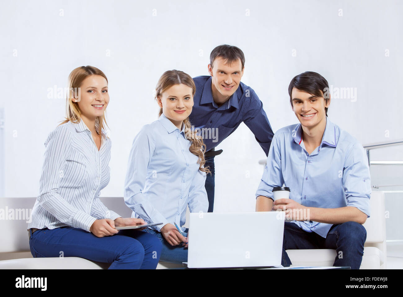 Four co-workers discussing business ideas in office Stock Photo - Alamy