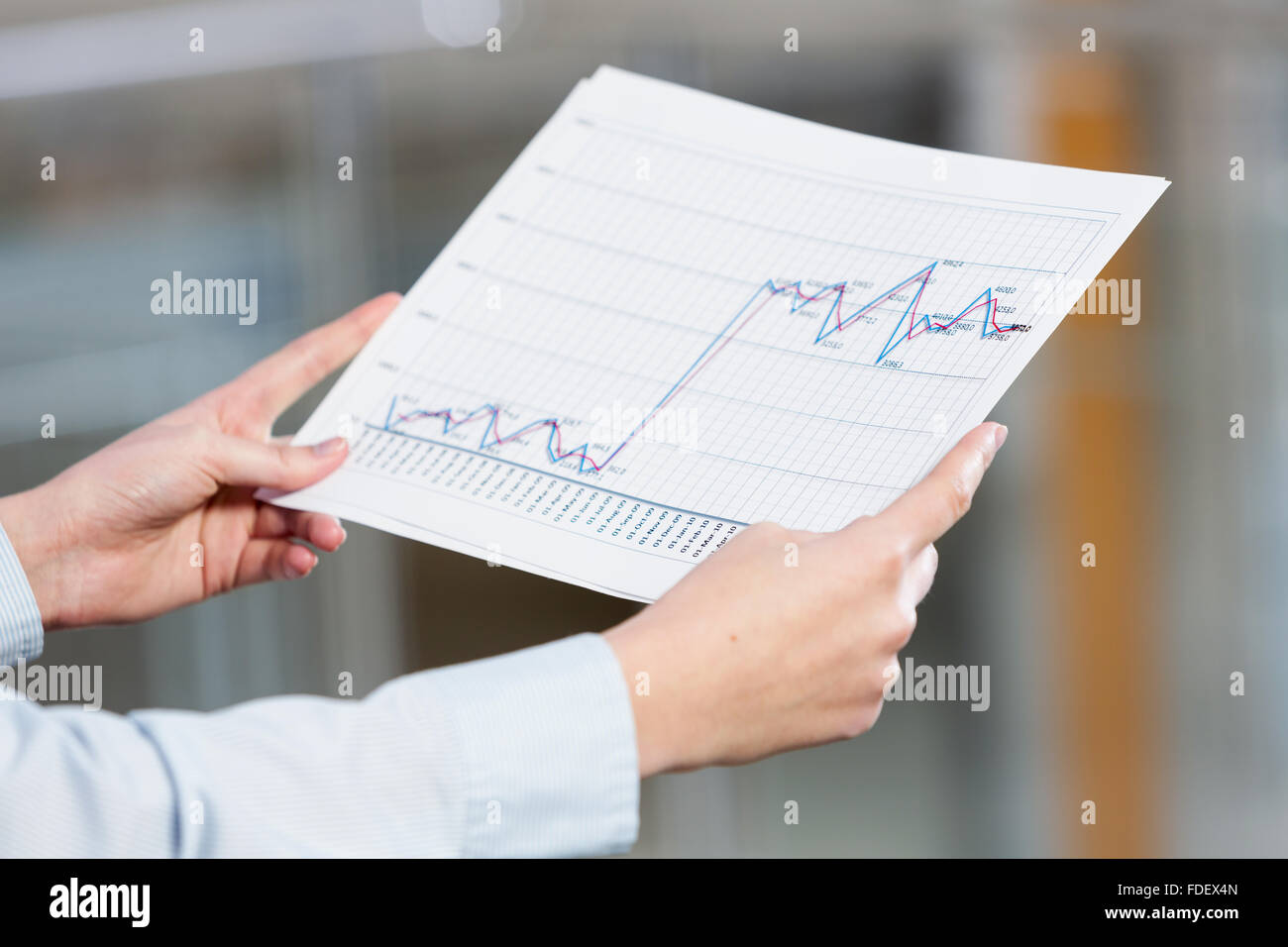 Close up of hands holding paper with graphs and diagrams Stock Photo ...
