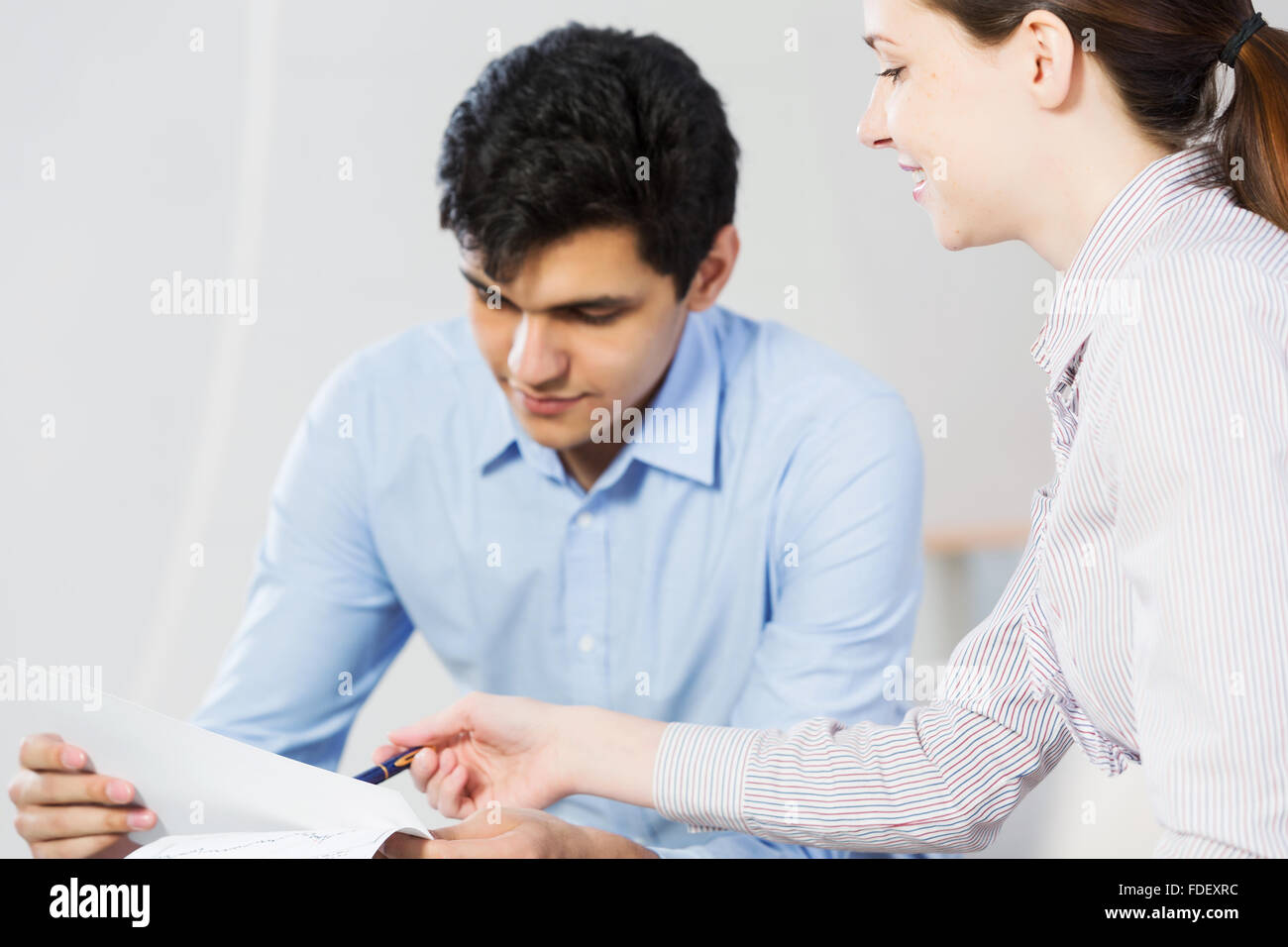 Two students working in cooperation and having discussion Stock Photo ...