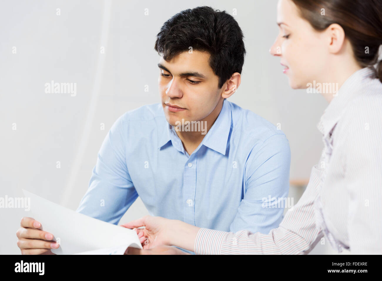 Two students working in cooperation and having discussion Stock Photo ...