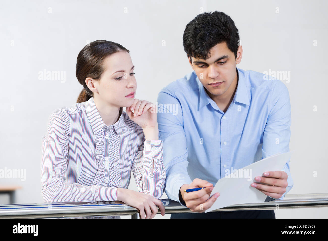 Two young people standing on balcony and communicating Stock Photo - Alamy