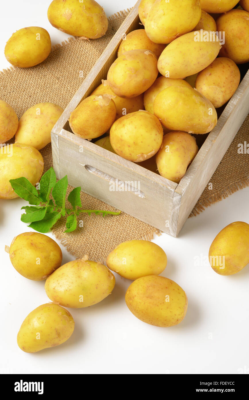 box of fresh potatoes on white background Stock Photo - Alamy