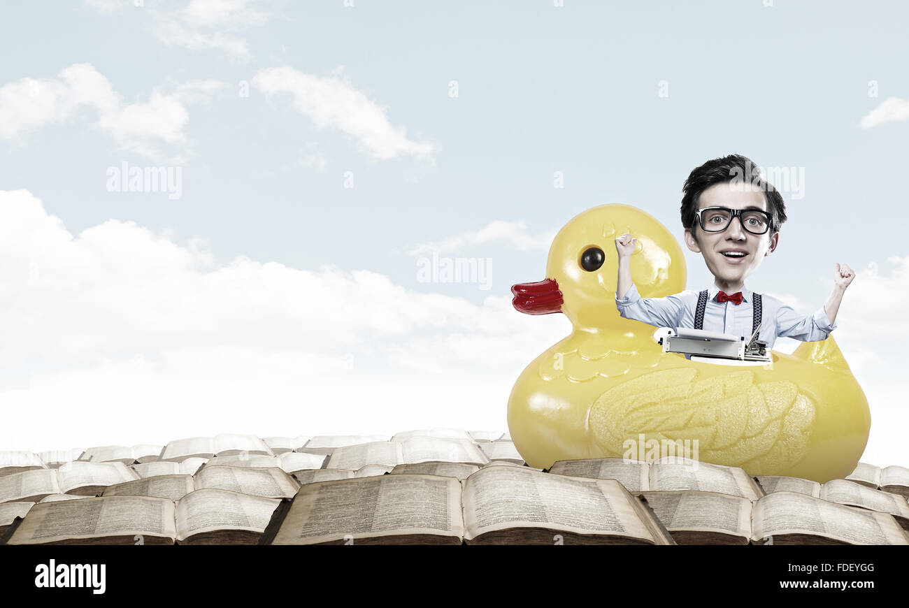 Young happy businessman riding yellow rubber duck Stock Photo - Alamy