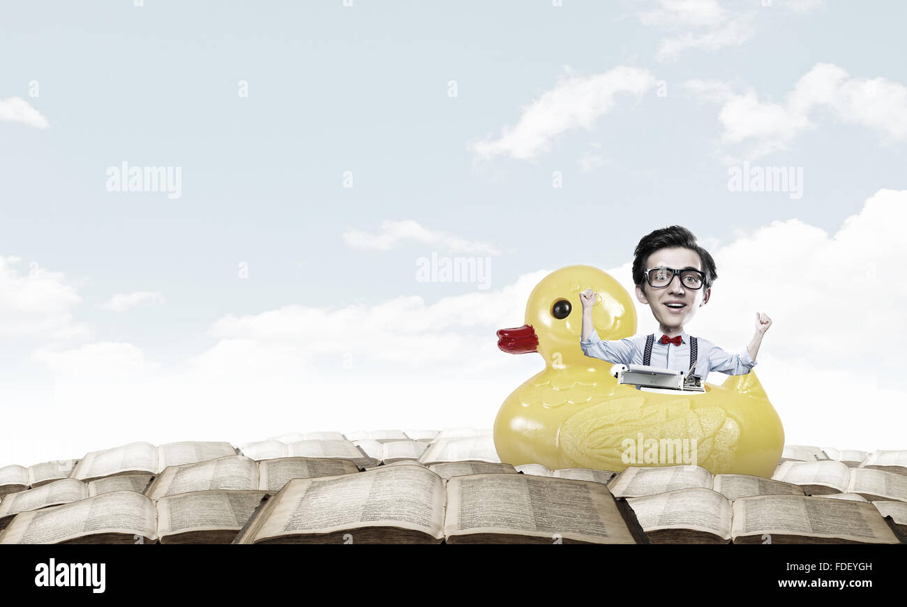 Young happy businessman riding yellow rubber duck Stock Photo - Alamy
