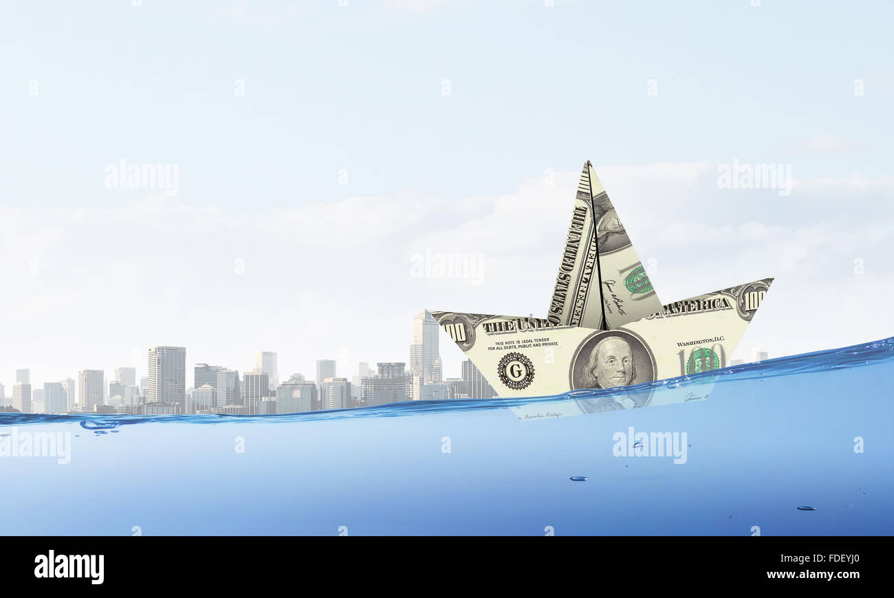 Ship made of dollar banknote floating in water Stock Photo - Alamy