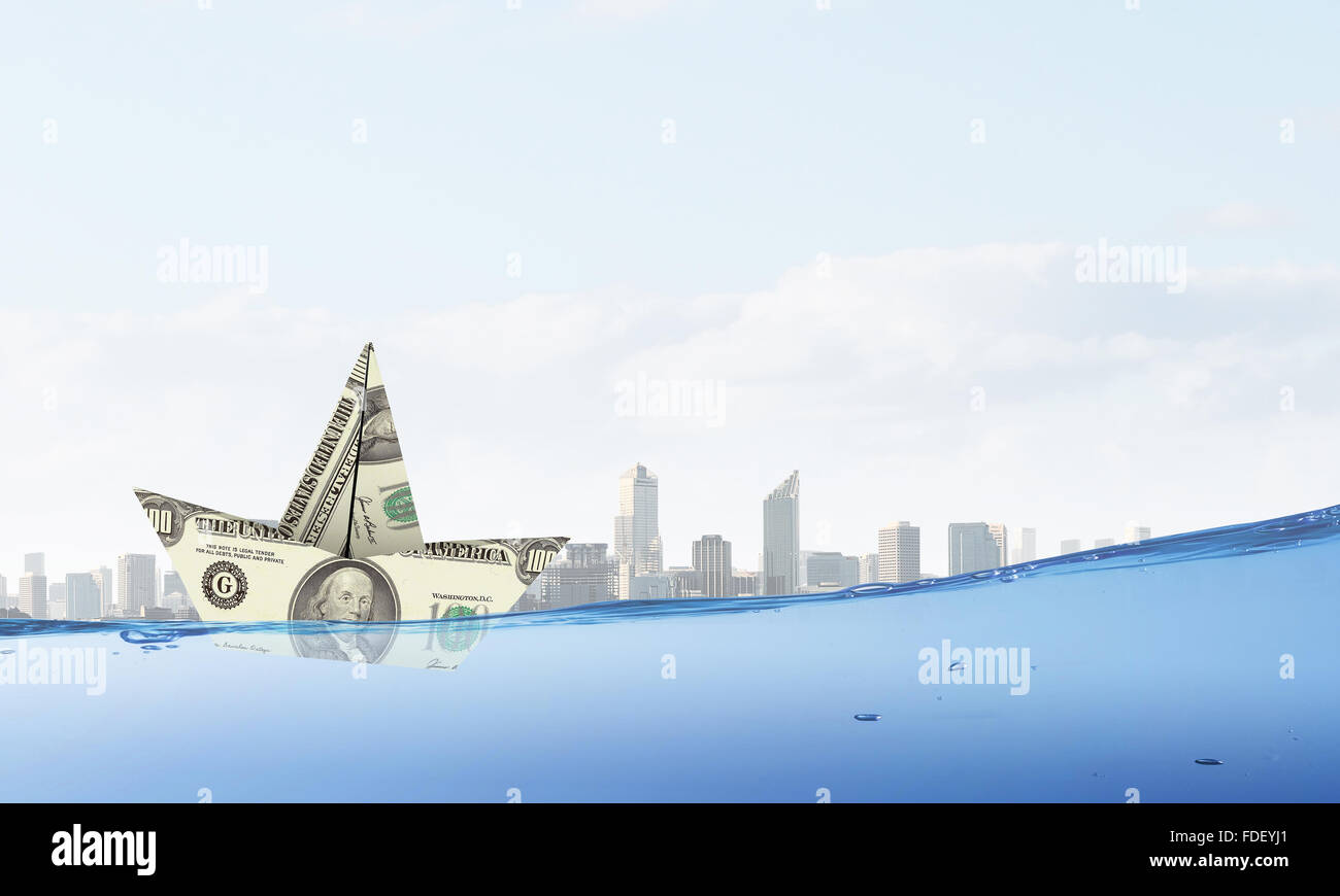 Ship made of dollar banknote floating in water Stock Photo - Alamy