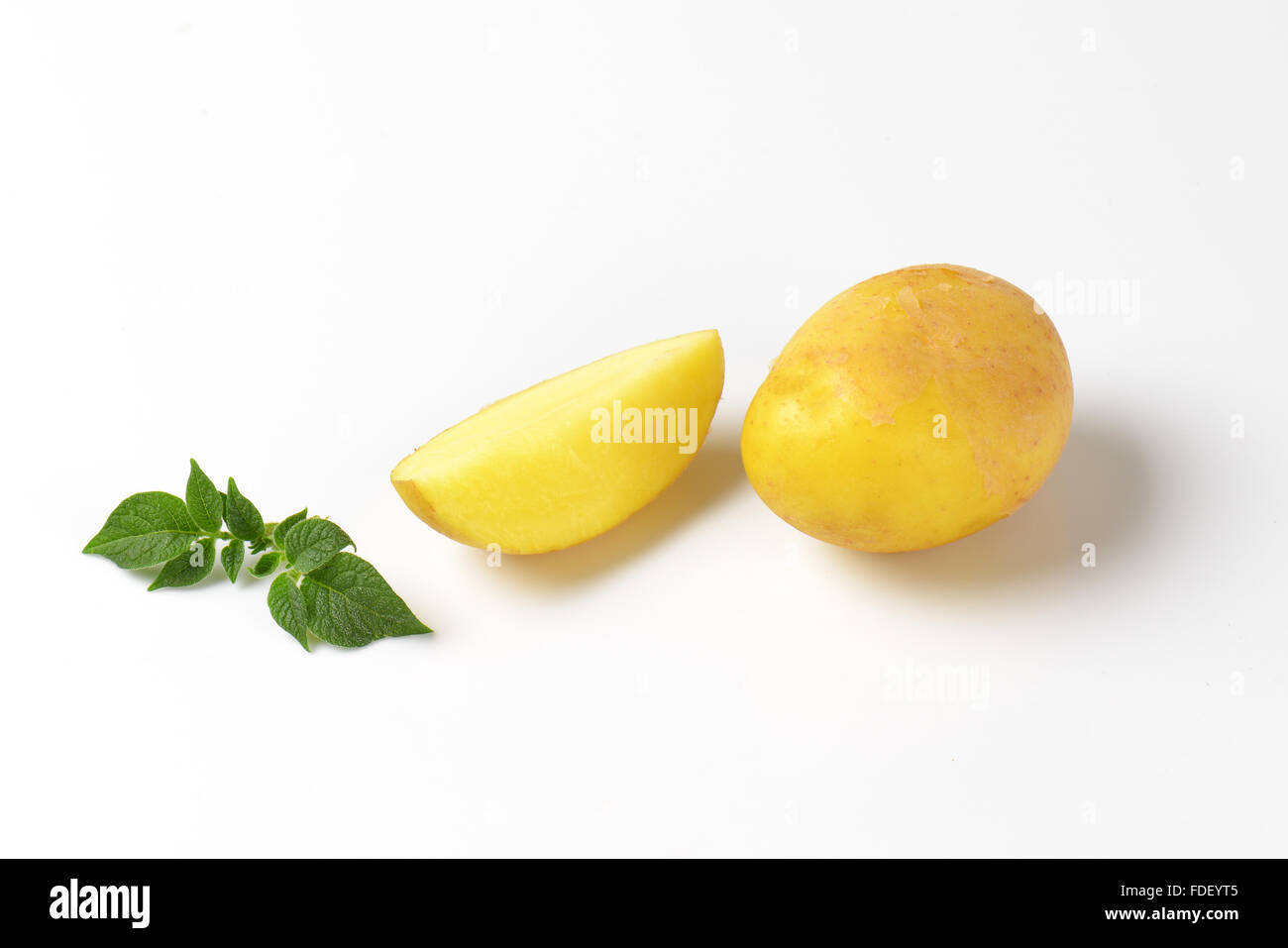 one and quarter baby potato with leaves on white background Stock Photo ...