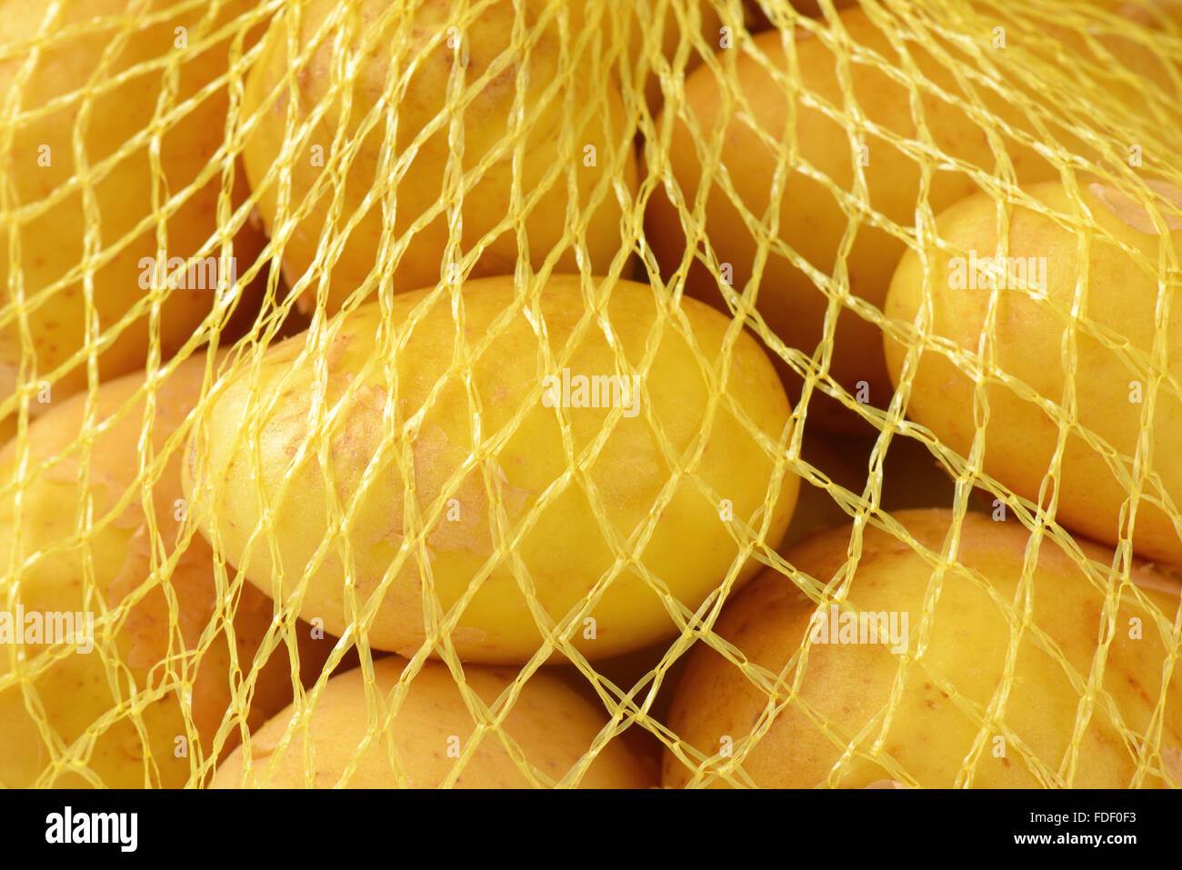 detail of baby potatoes in netting sack Stock Photo - Alamy