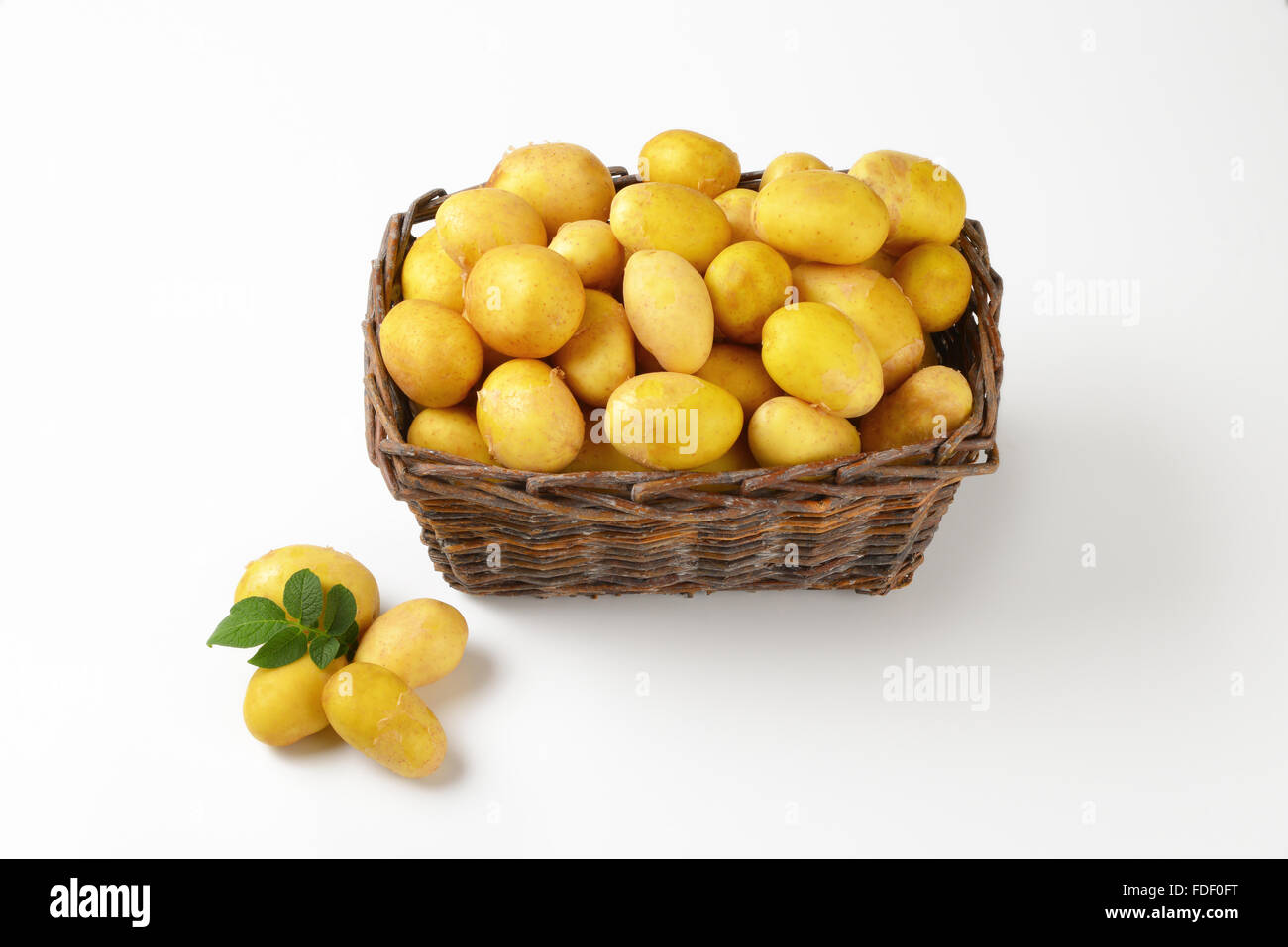 fresh baby potatoes in brown wicker basket on white background Stock ...