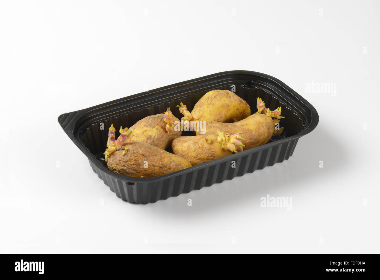 box of old sprouting potatoes on white background Stock Photo - Alamy