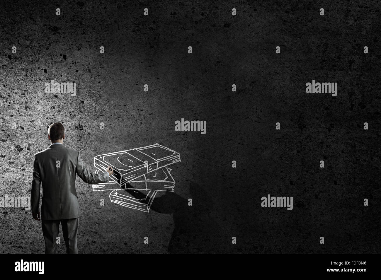 Back view of businessman drawing money banknotes on wall hi-res stock ...
