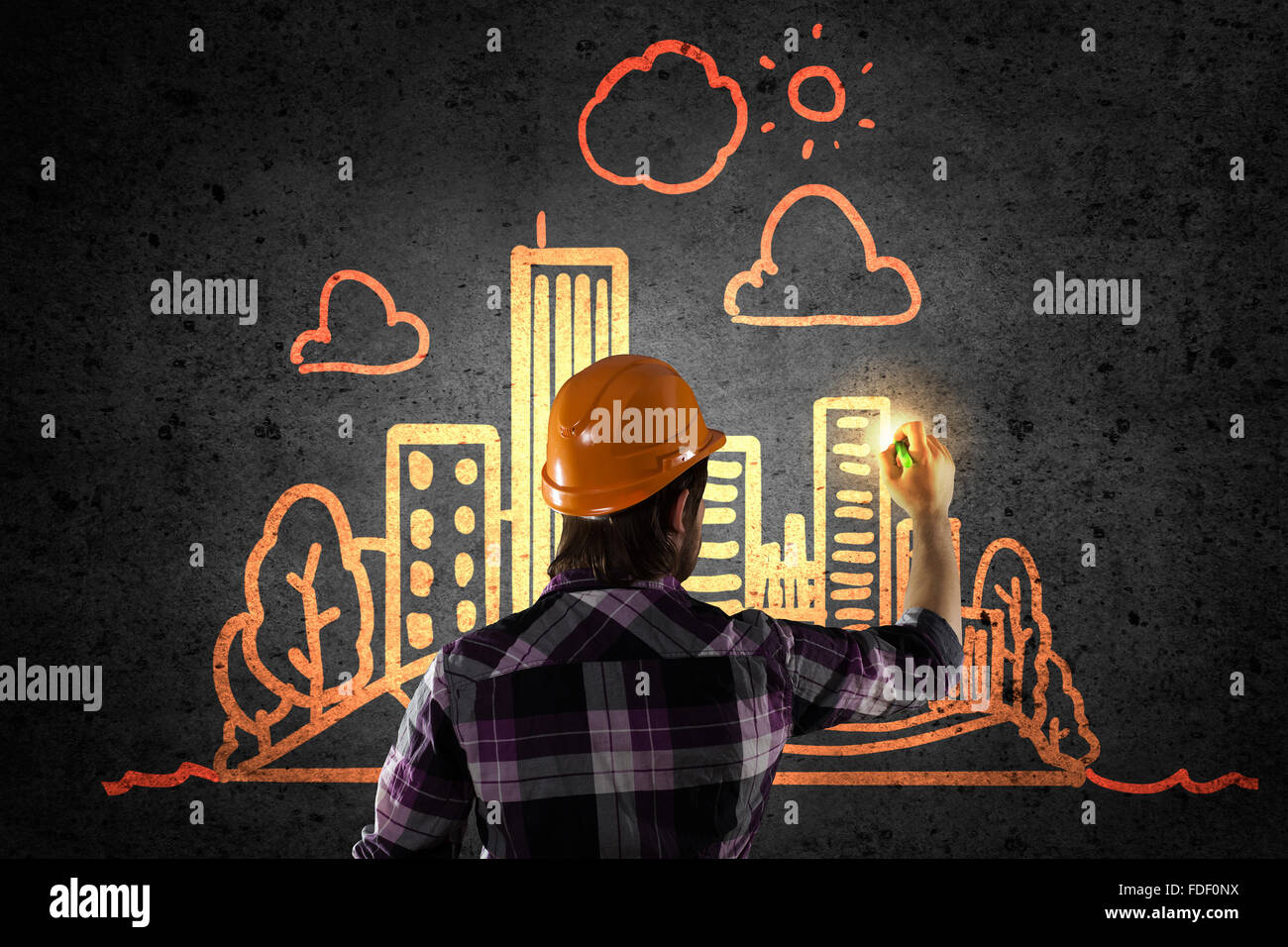 Back view of man engineer drawing building sketches on wall Stock Photo ...