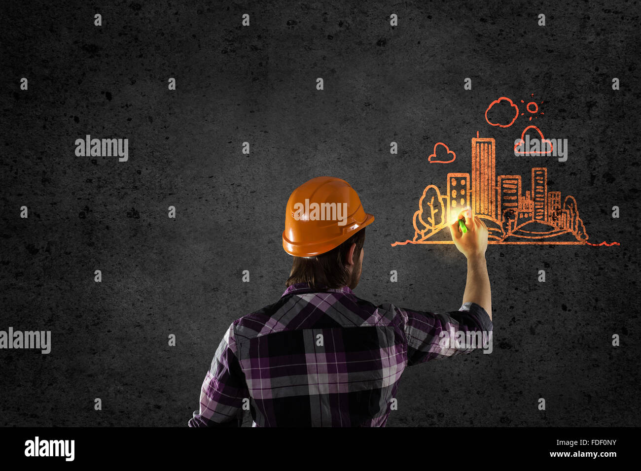 Back view of man engineer drawing building sketches on wall Stock Photo ...