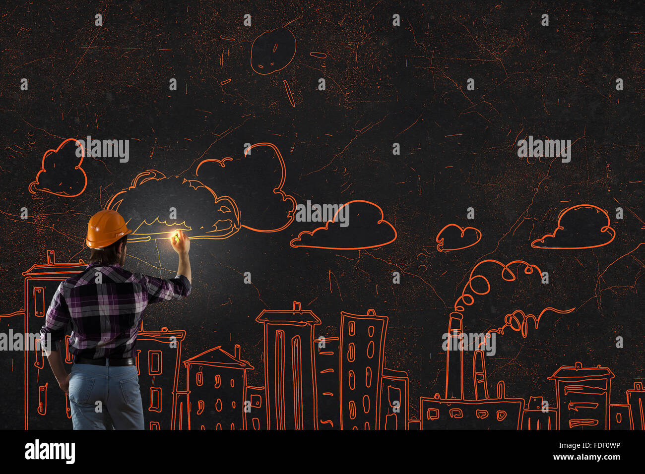 Back view of man engineer drawing building sketches on wall Stock Photo ...