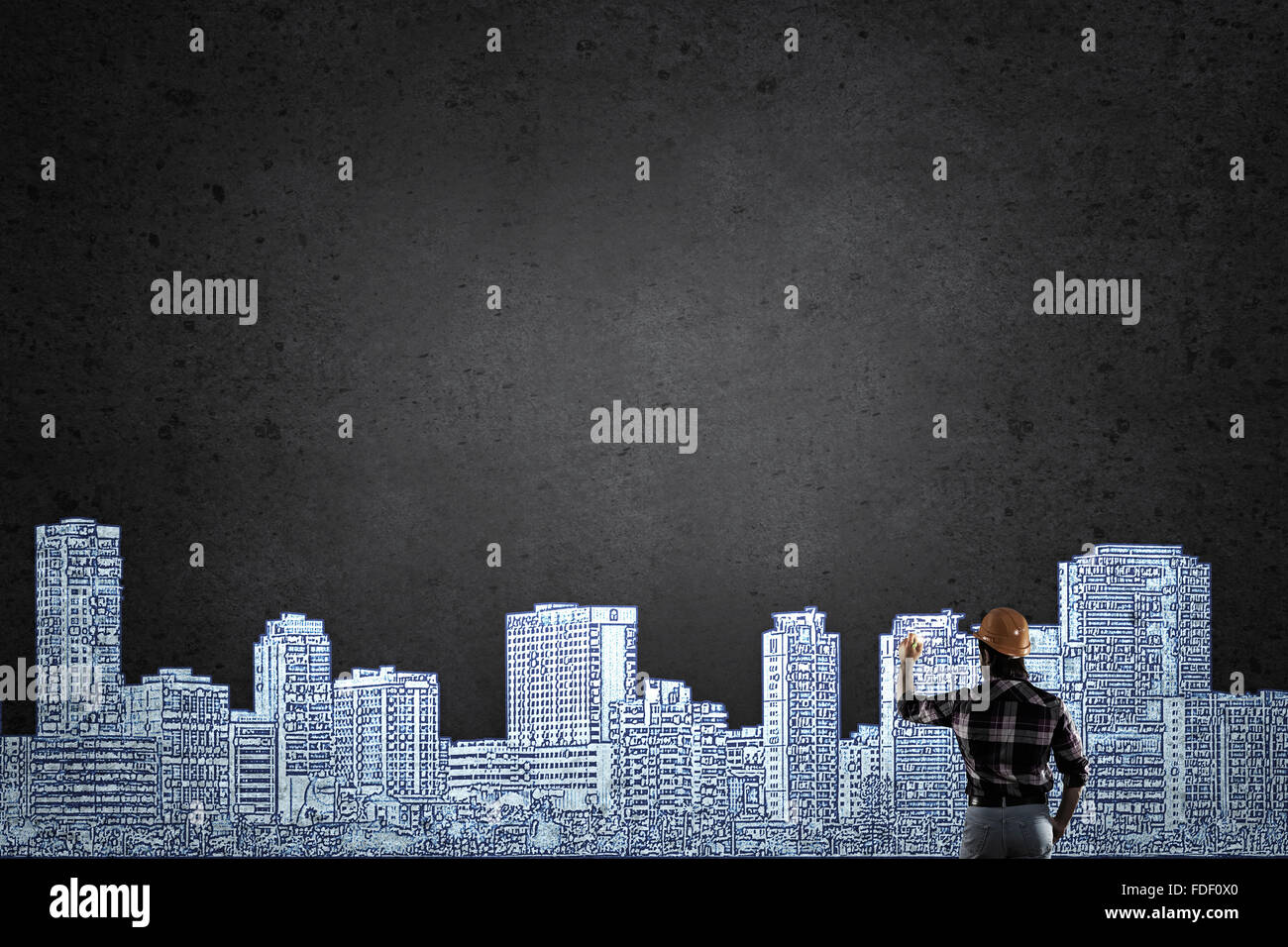 Back view of man engineer drawing building sketches on wall Stock Photo ...