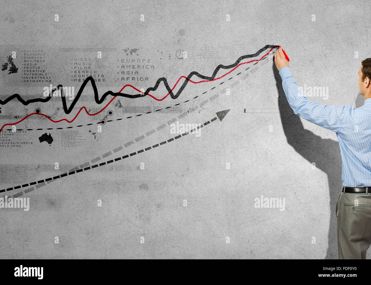 Back view of businessman drawing graphs on wall Stock Photo - Alamy