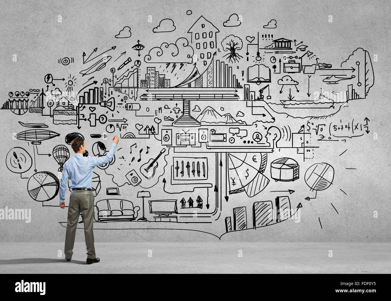 Rear view of businessman drawing business sketch on wall Stock Photo ...
