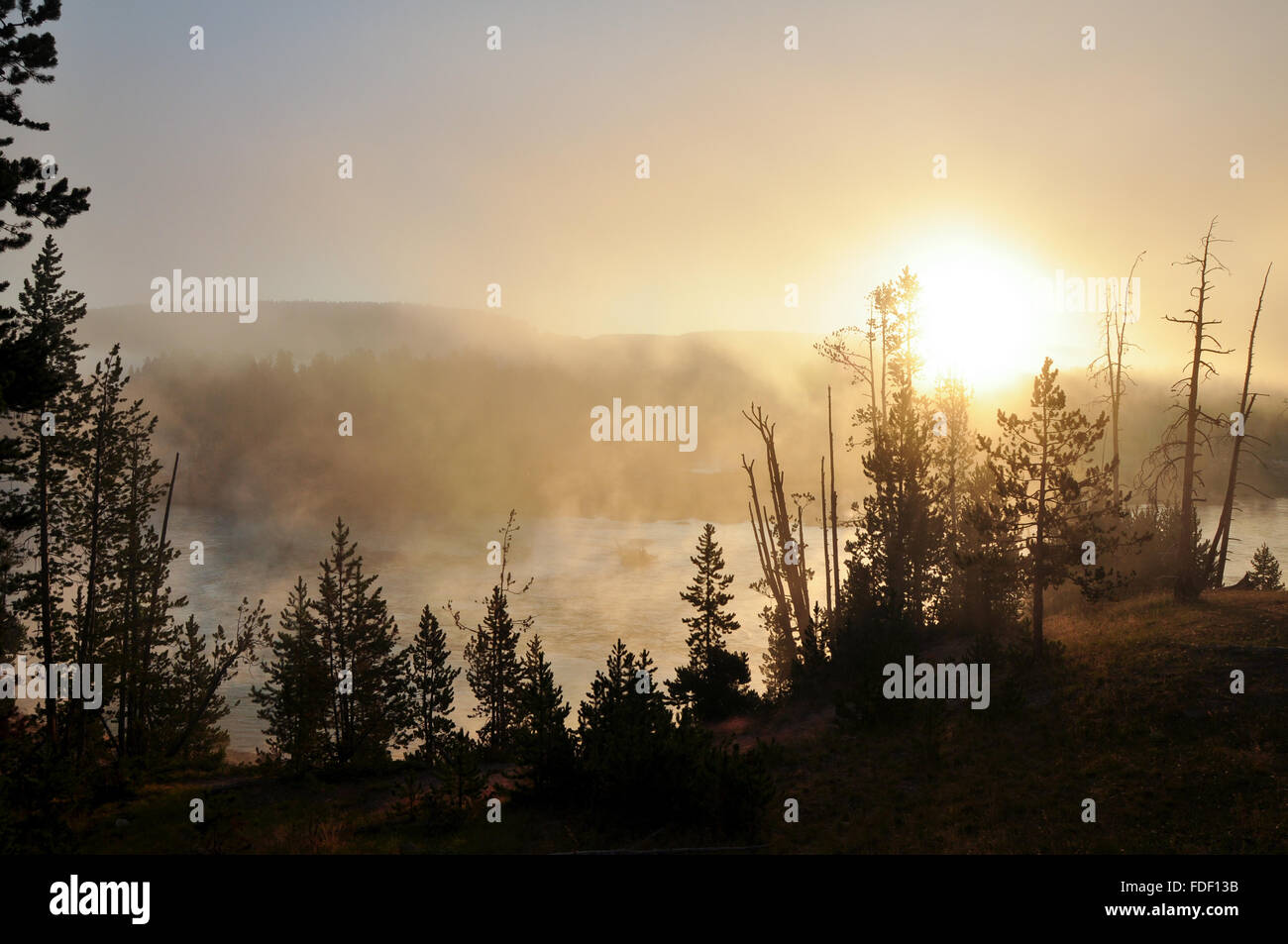 Sunrise over a misty lake Stock Photo - Alamy