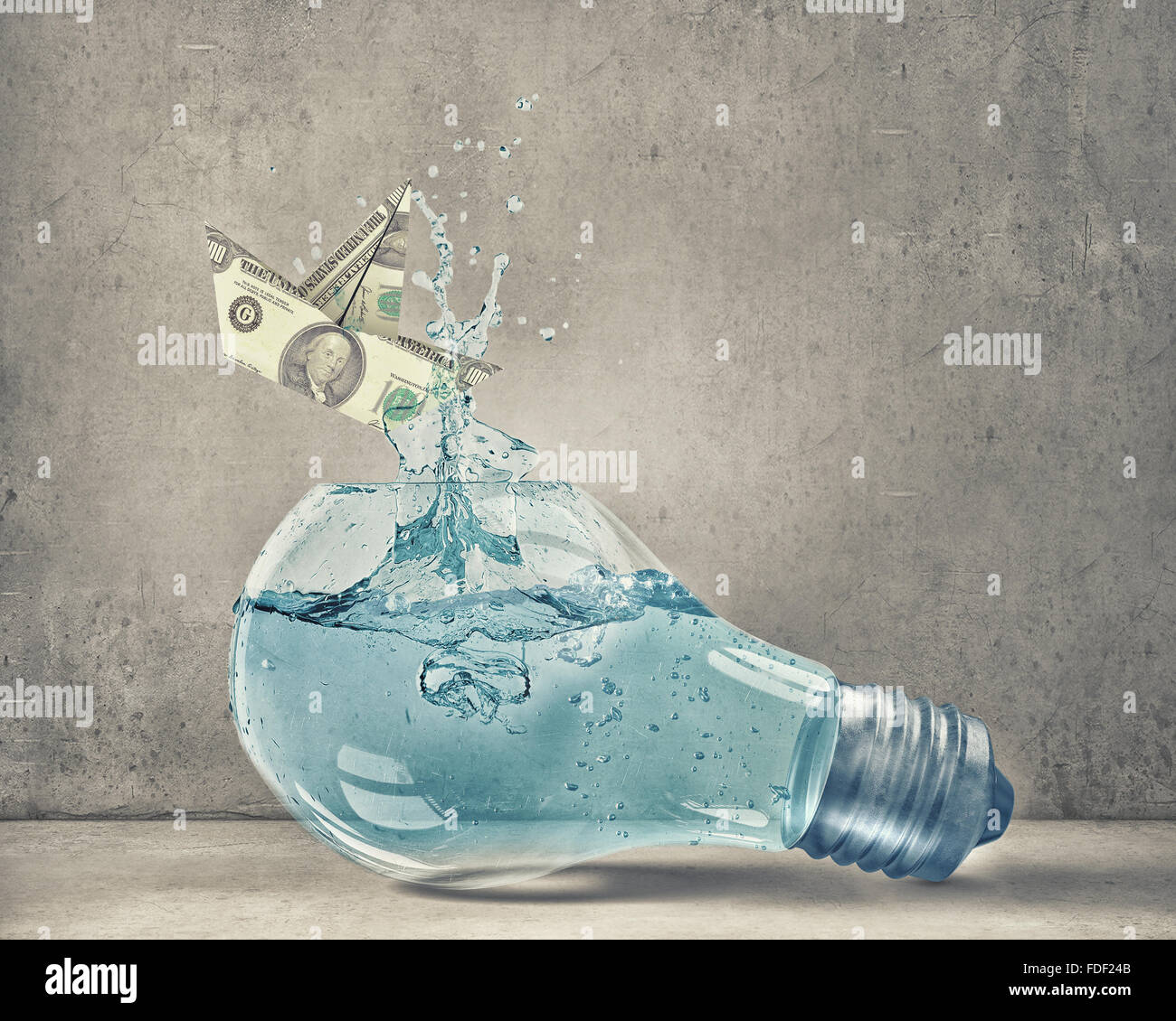 Glass light bulb filled with water and dollar ship floating inside ...