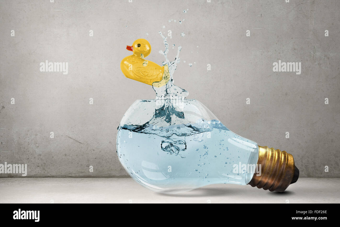 Glass light bulb yellow rubber toy inside on blue background hi-res ...