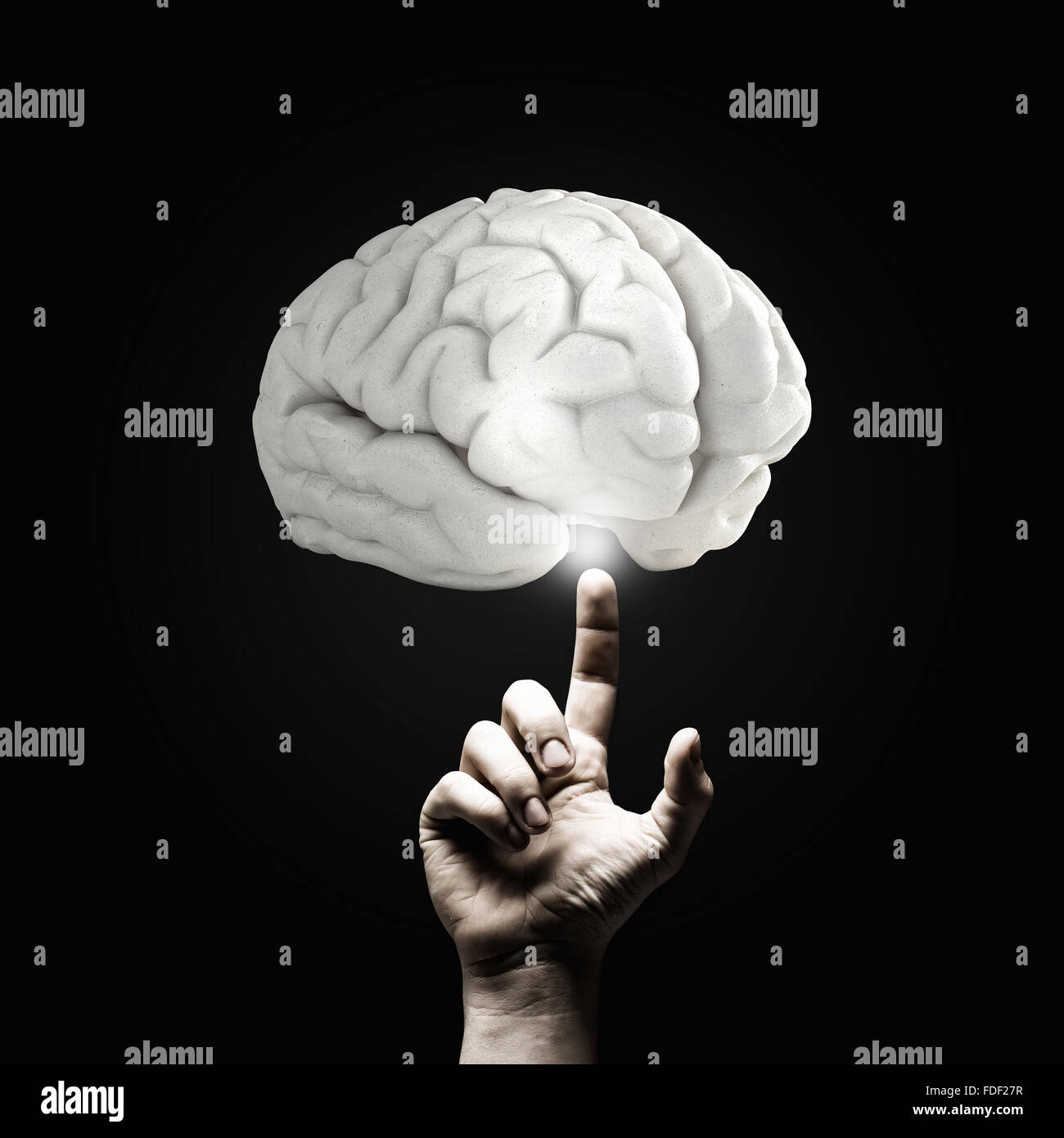 Human hand pointing with finger at brain icon Stock Photo - Alamy