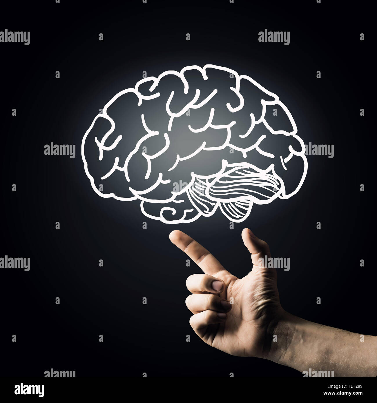 Human hand pointing with finger at brain icon Stock Photo - Alamy